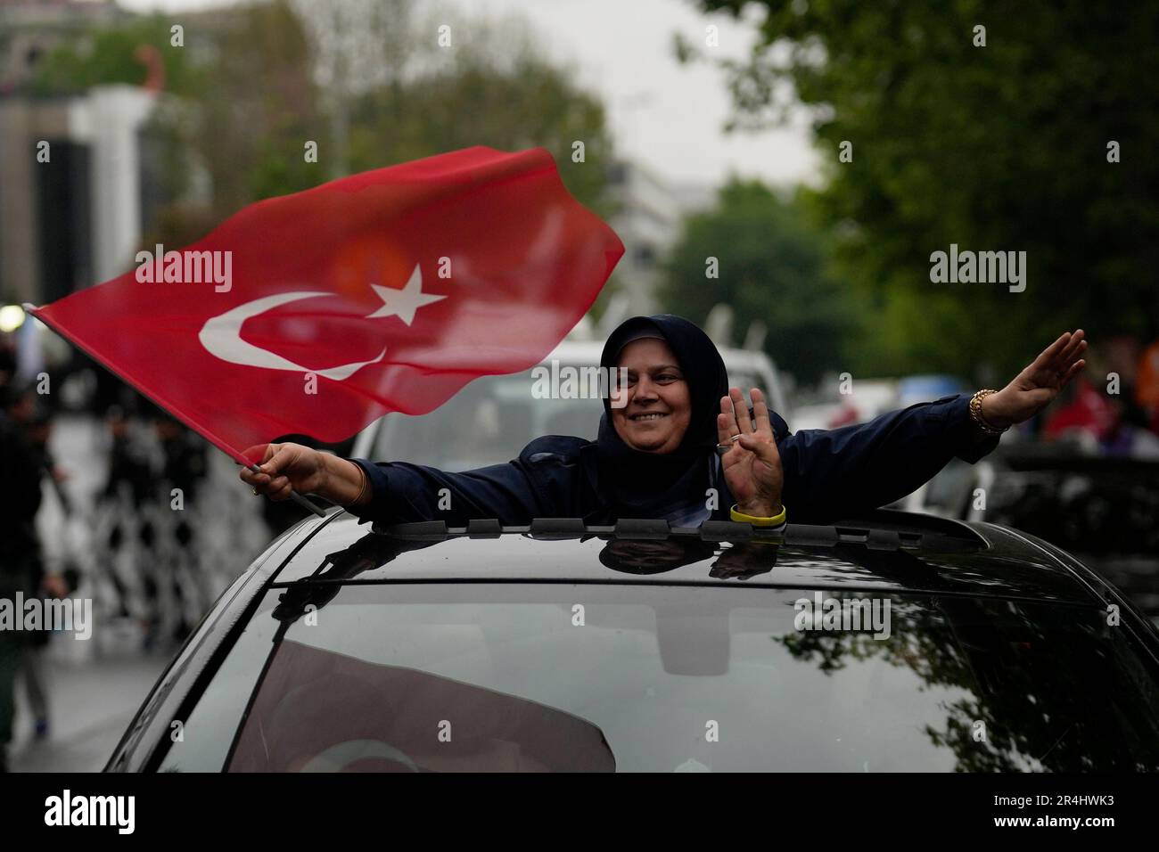 A supporter of the President Recep Tayyip Erdogan waves a Turkish flag ...