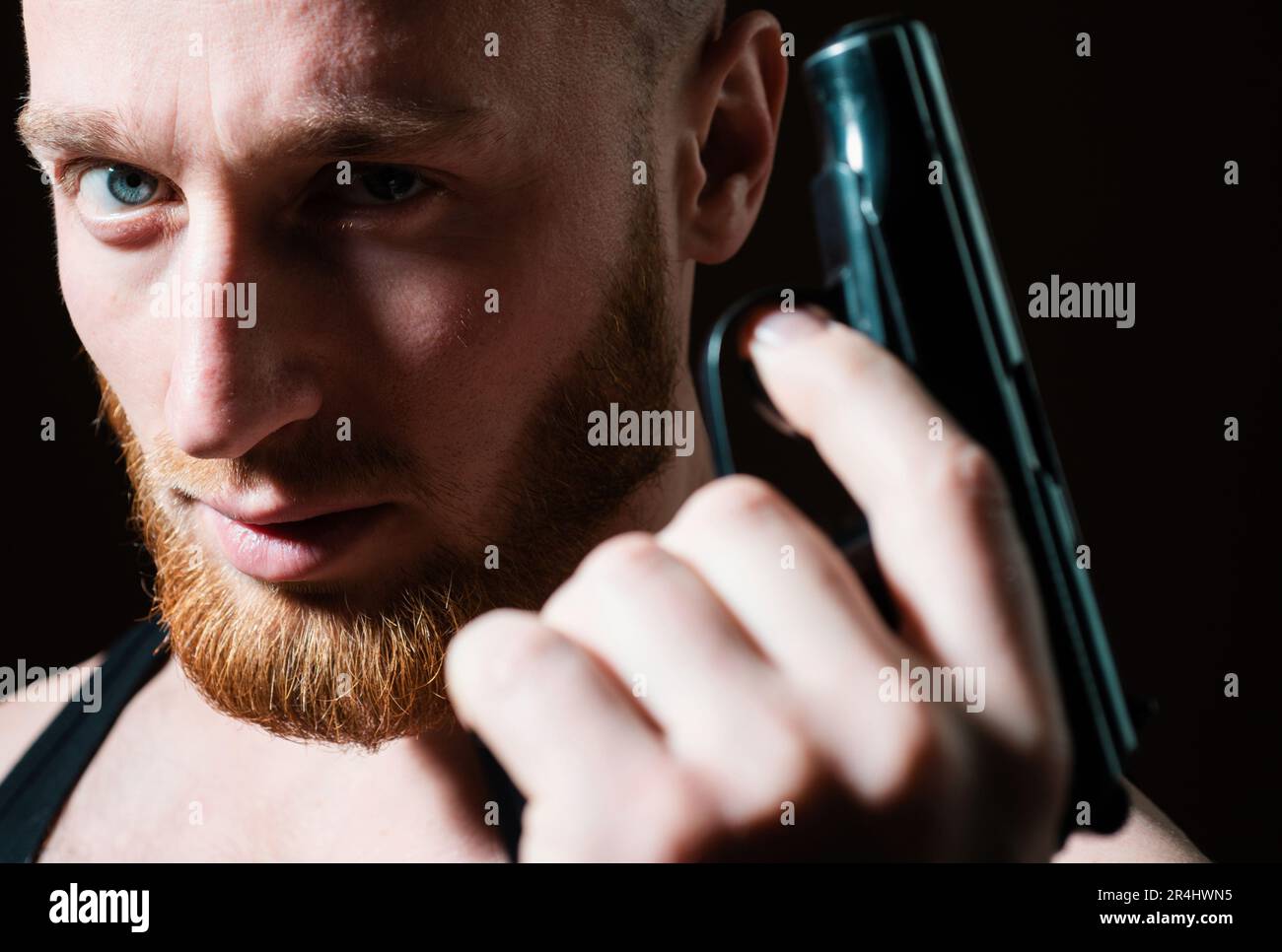 Gangster in action, killer aiming pistol gun. Close up portrait of guy ...