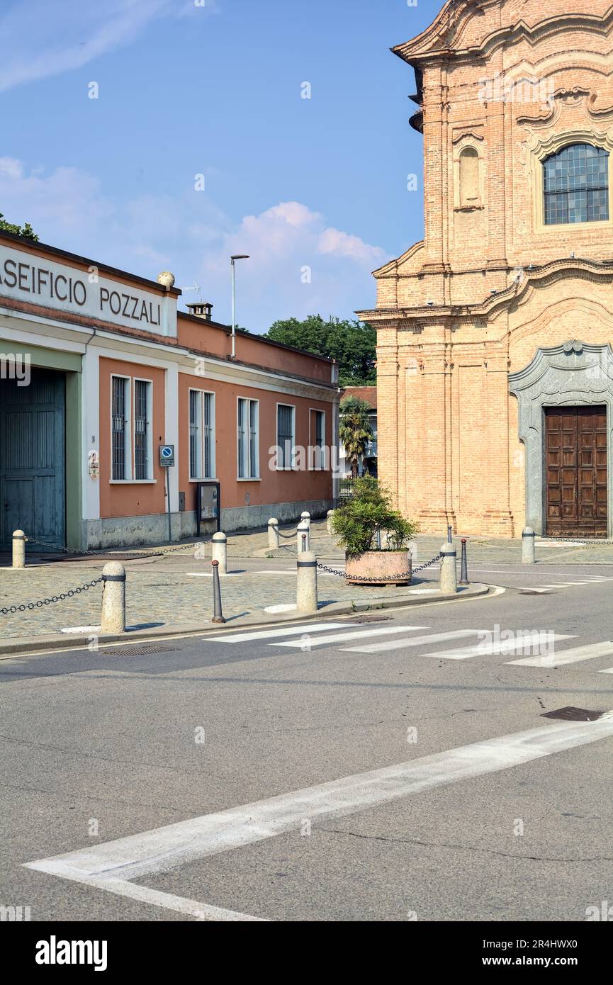 Square in front of a church and a warehouse on a sunny day in a village ...
