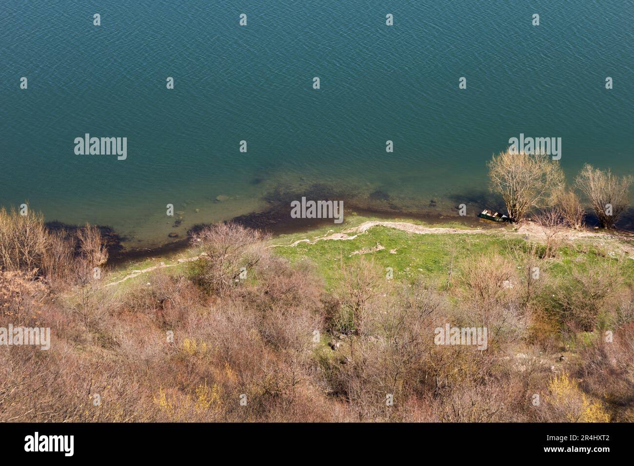 River bank with boat in spring time from top to down against background ...