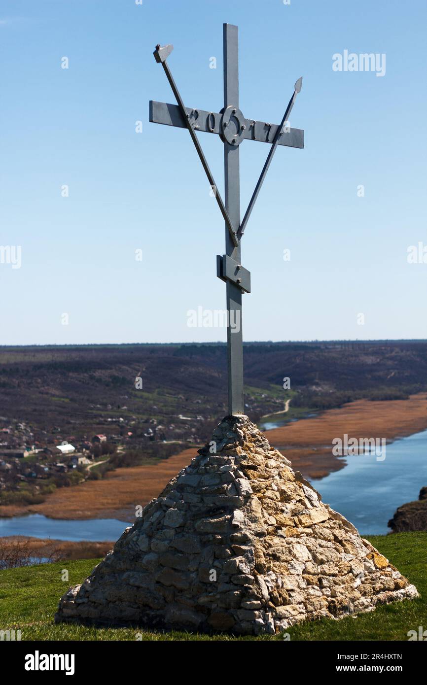 Iron cross on a stone pedestal against background of river Stock Photo ...