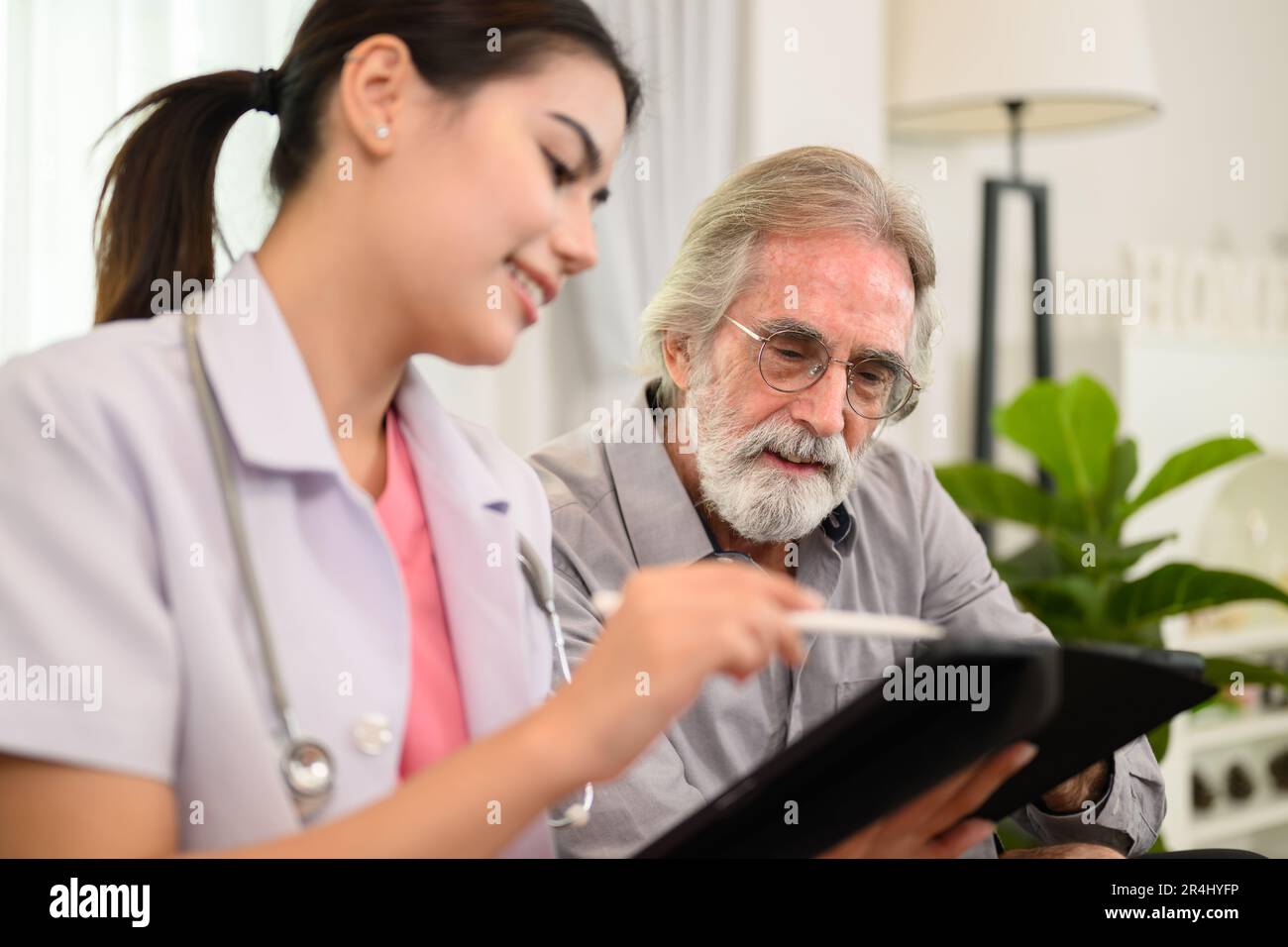 Professional female doctor with stethoscope visiting patient Stock ...