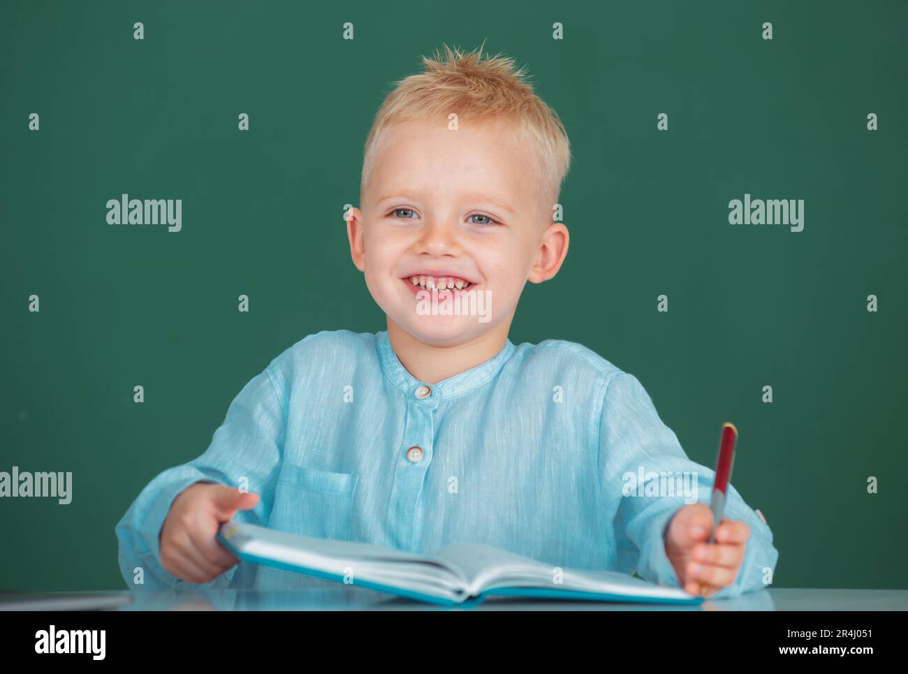 School child student learn lesson sitting at desk studying. Kid writing ...