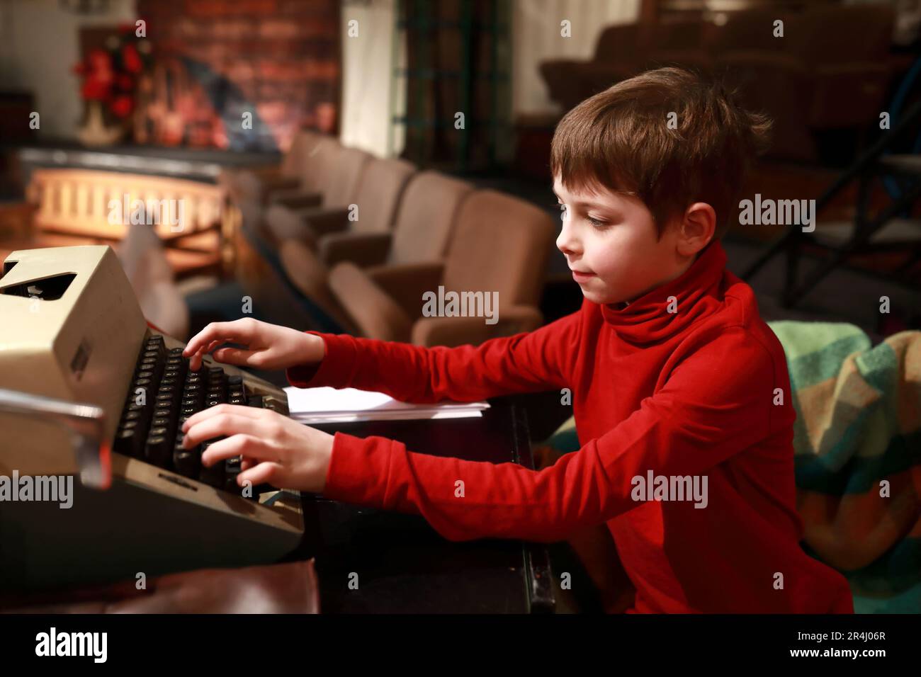 Portrait of child studying retro typewriter indoor Stock Photo - Alamy