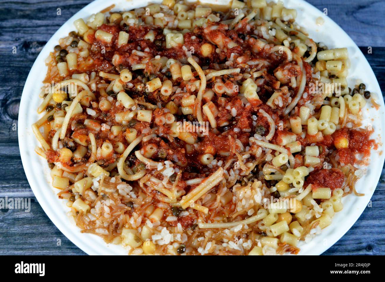 Egyptian cuisine of Koshary, a popular street food made of rice ...