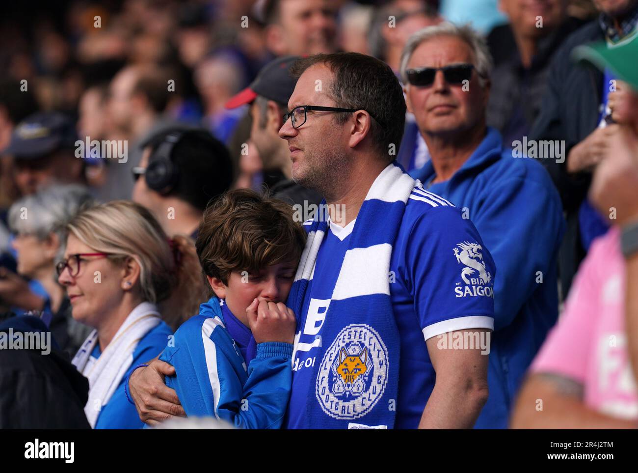 A young Leicester City fan is consoled after the Premier League match ...