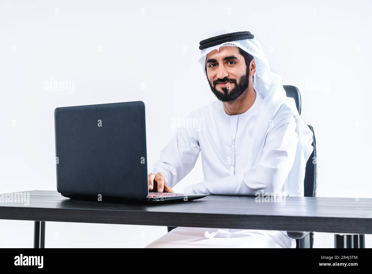 Emirate middle-eastern businessman wearing kandora working in the ...