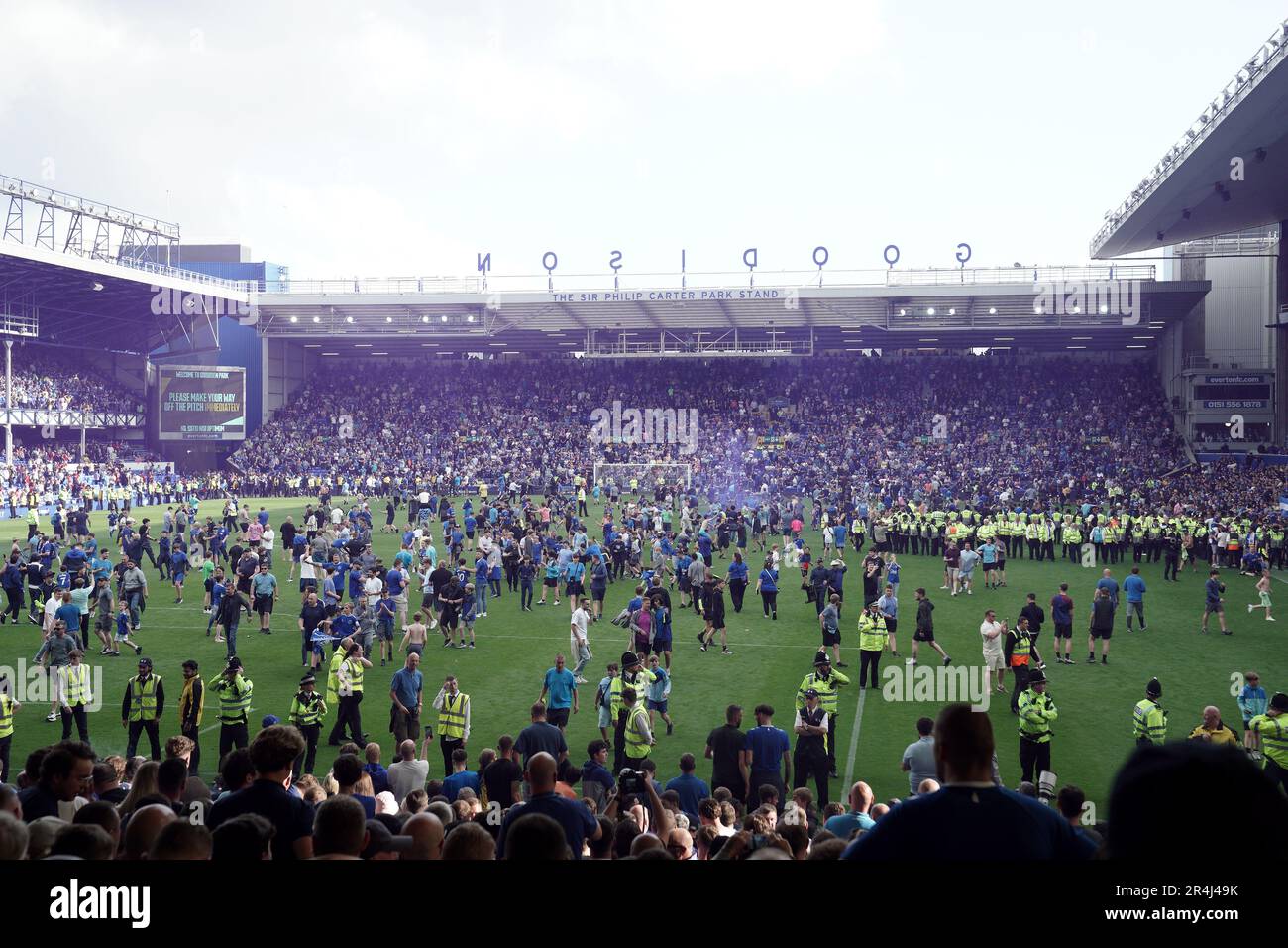 Everton fans invade the pitch after securing their safety by winning ...