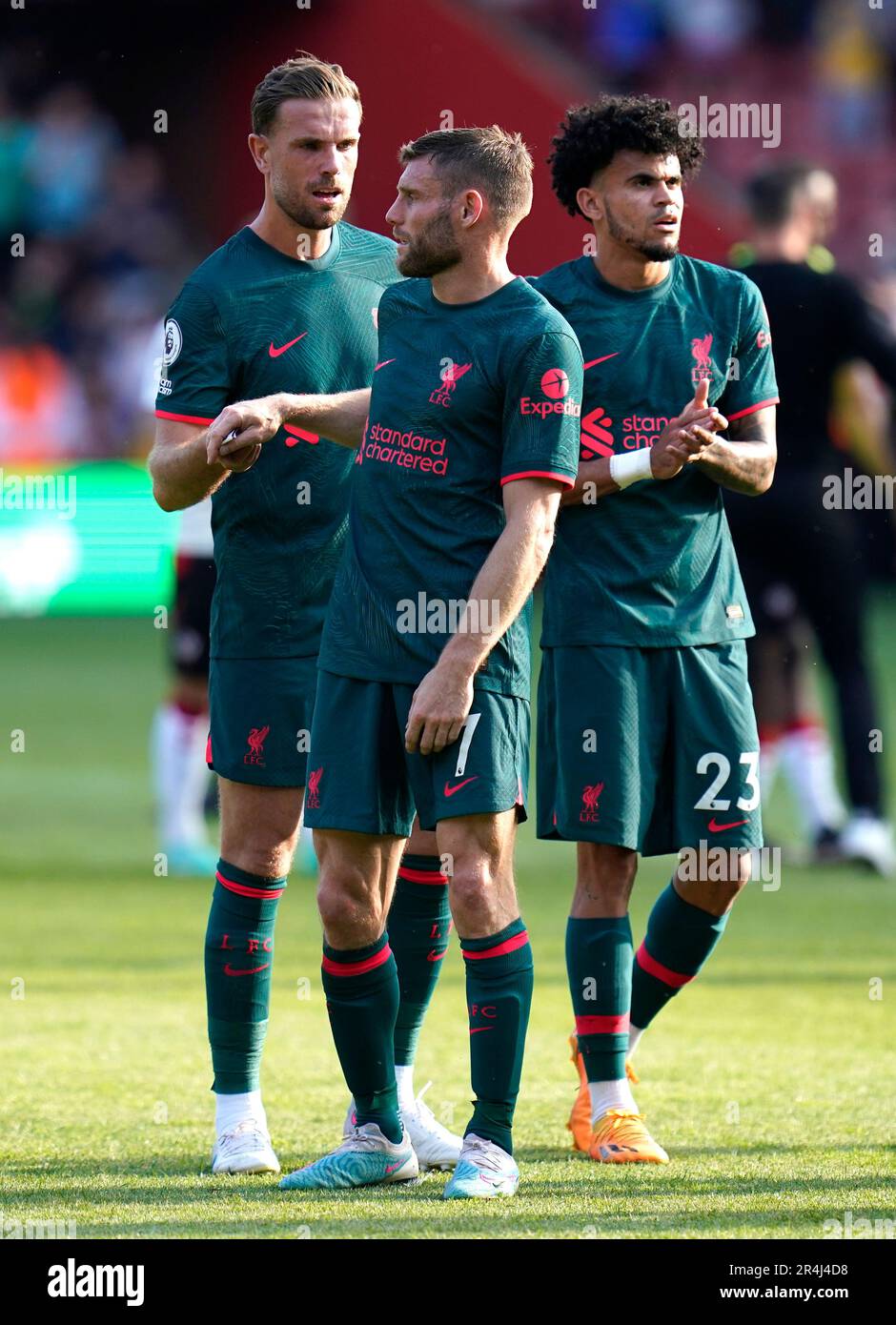 Liverpool's Jordan Henderson (left) hands James Milner the captains ...