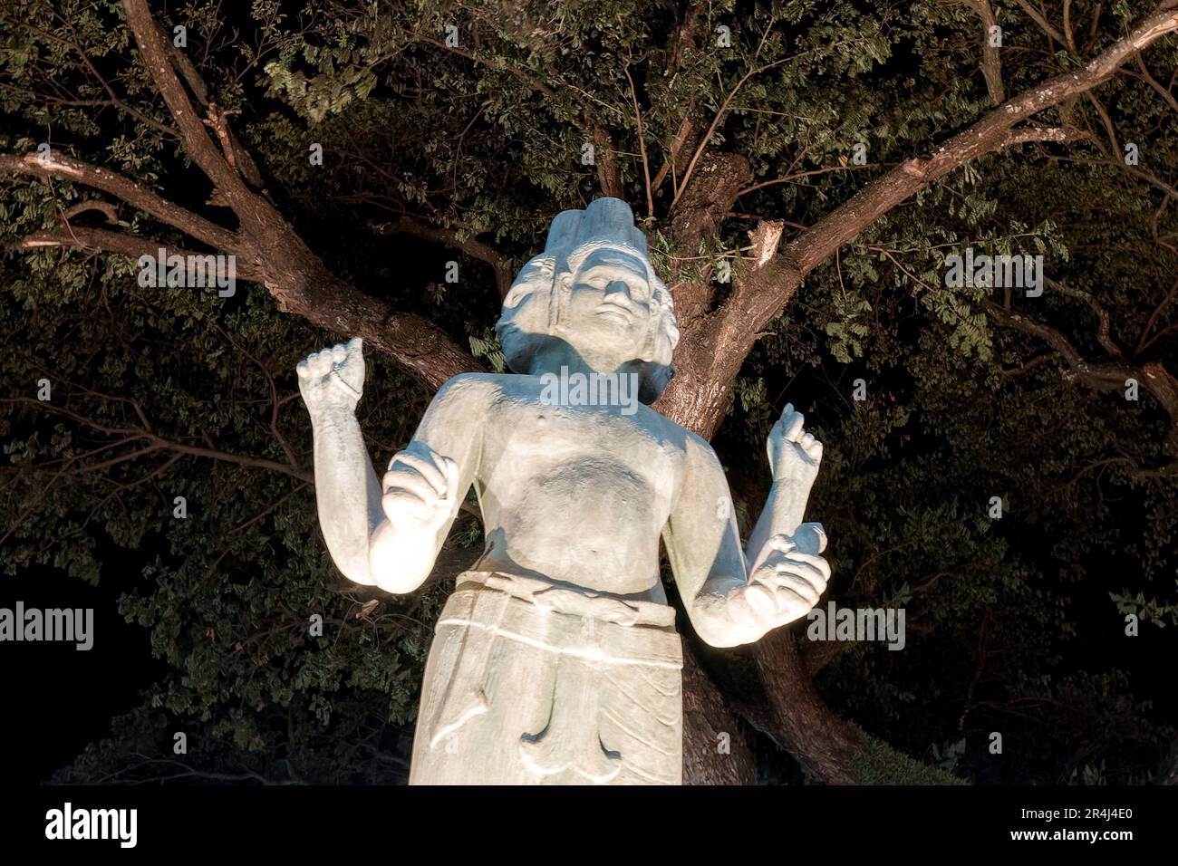 A sculptural image of a multi-faced and multi-armed Hindu deity in the ...