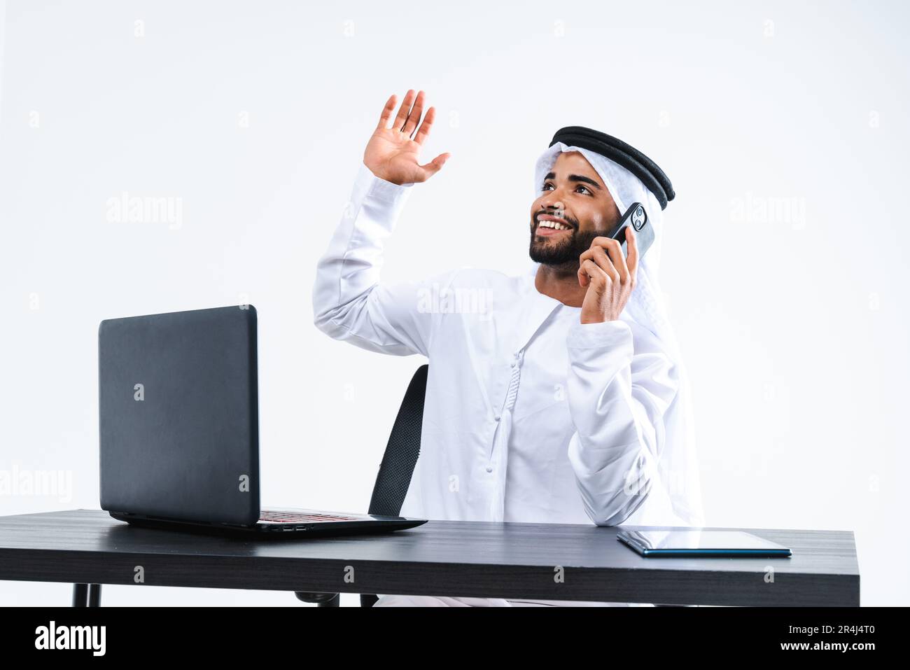 Emirate middle-eastern businessman wearing kandora working in the ...