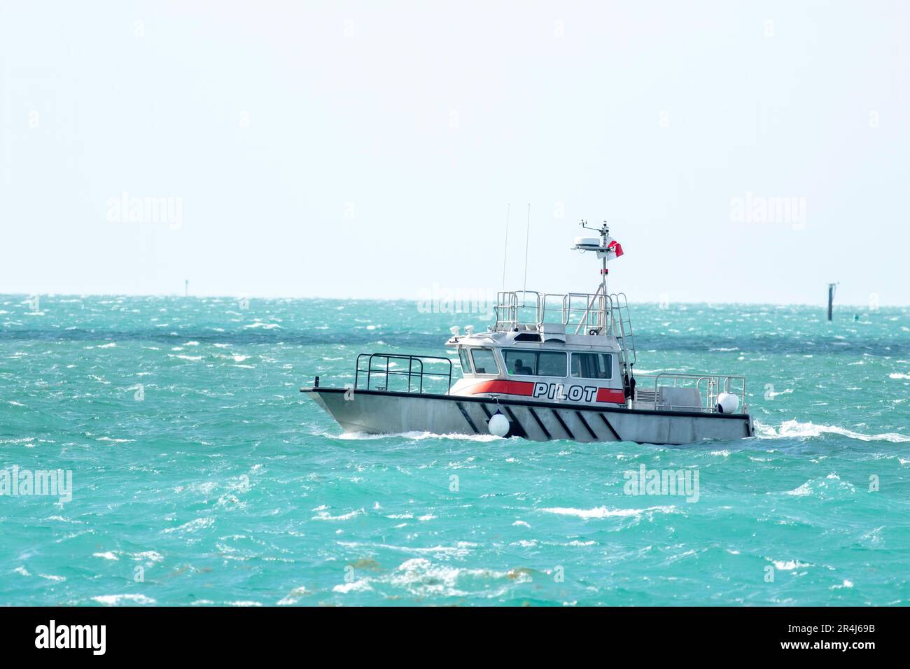 A pilot boat heading out of the channel to guide a cruise ship in Key ...