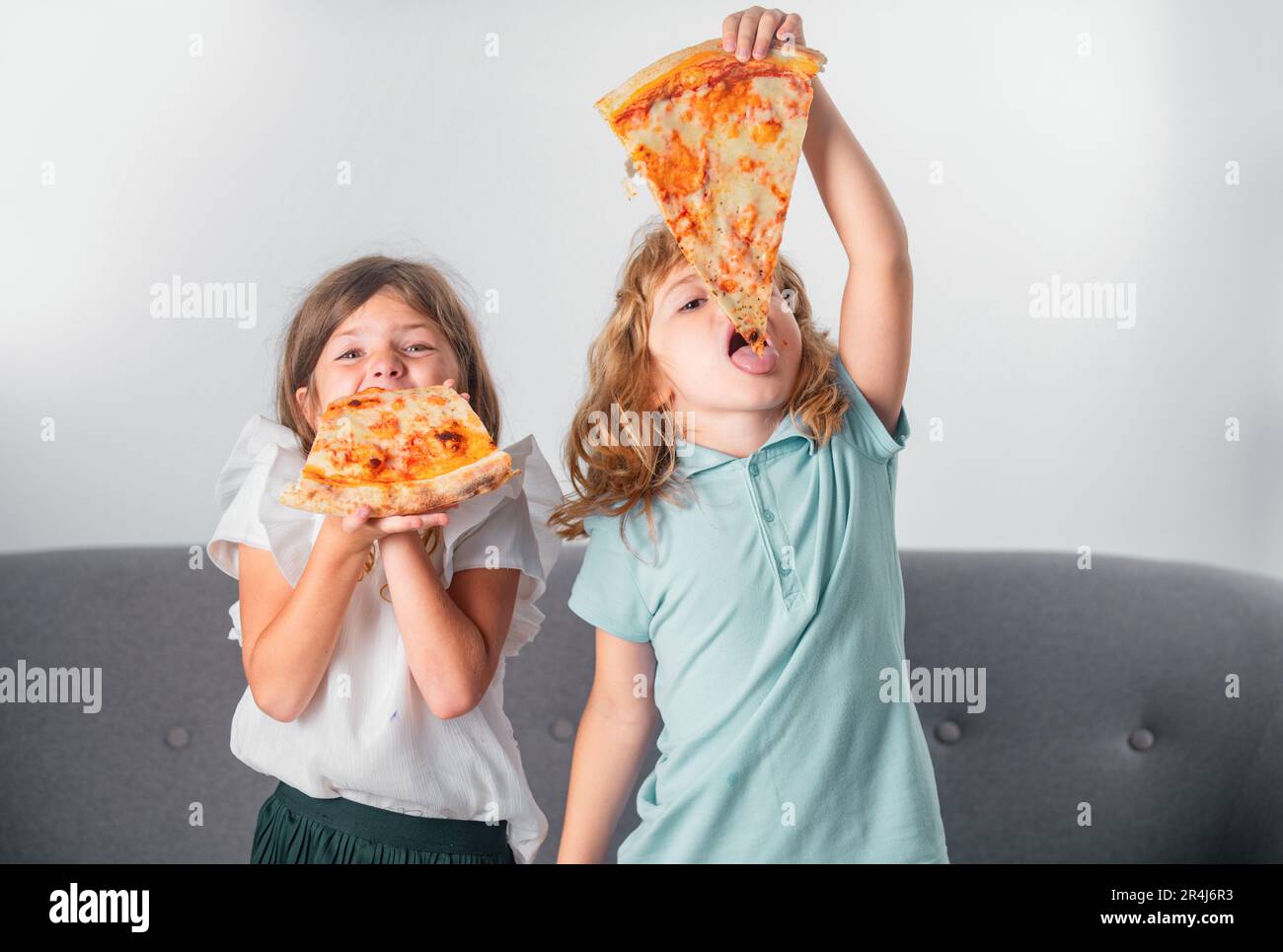 Children eating pizza. Cute funny kids little girl and boy eating tasty ...