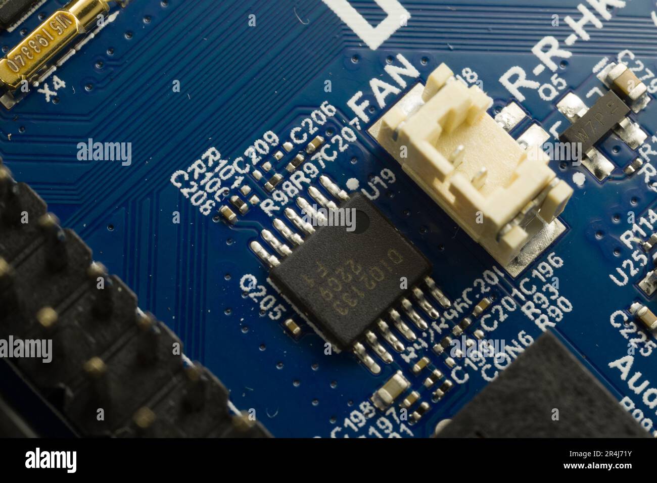 Close up of a PCB with a chip ant components like capacitors and ...
