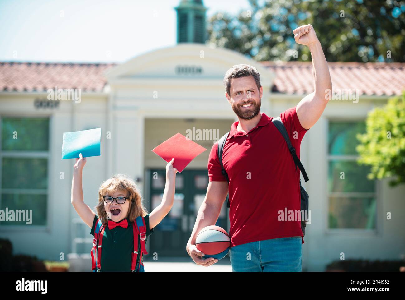 Excited father and son walking trough school park. Portrait of man ...