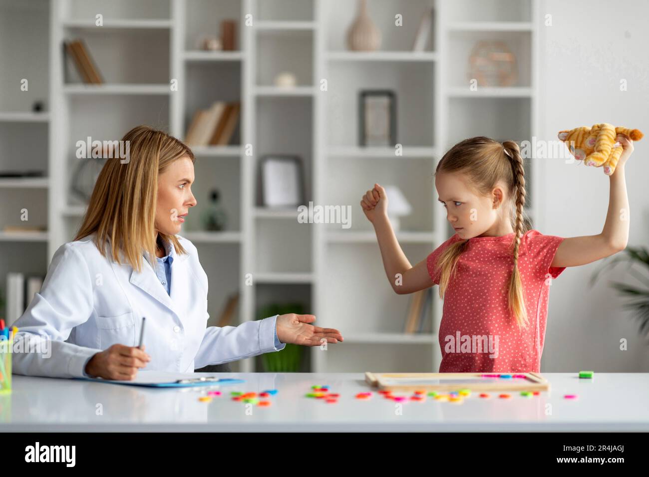 Disobedient bad tempered little girl throwing tantrum at appointment ...