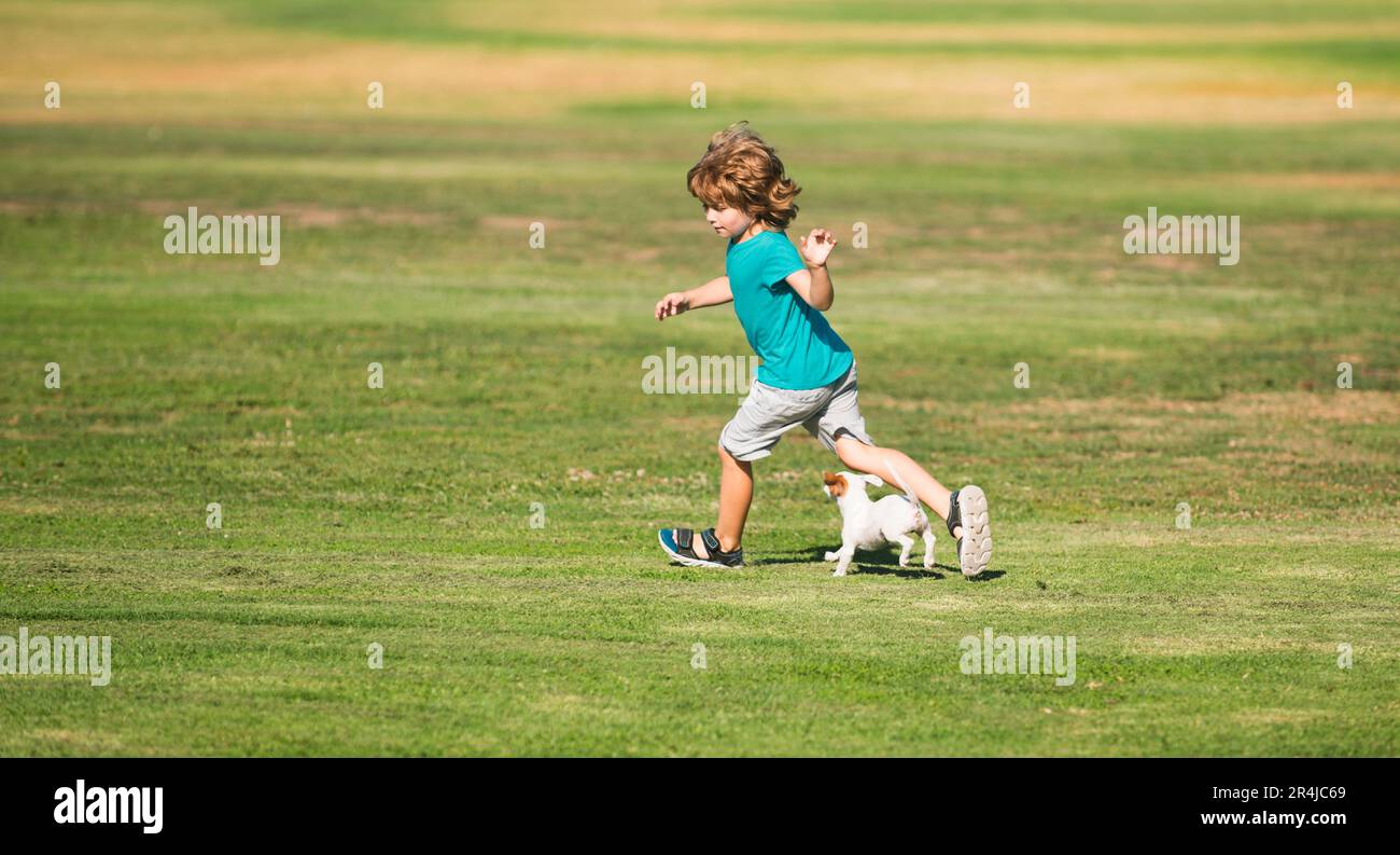 Running dog. Happy child run with a dog outdoor Stock Photo - Alamy