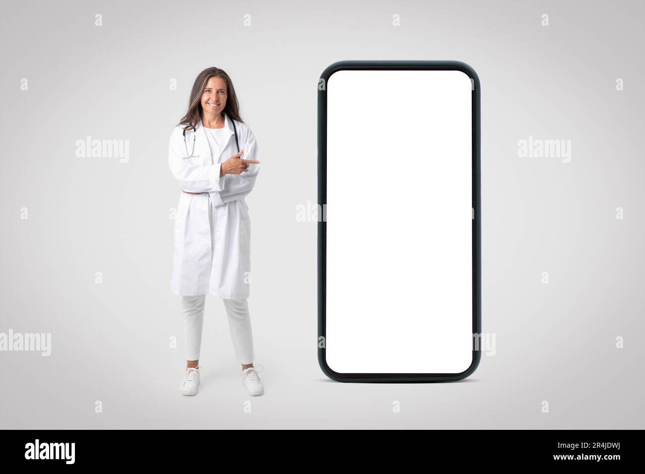 Medical offer. Professional woman doctor standing near giant blank ...