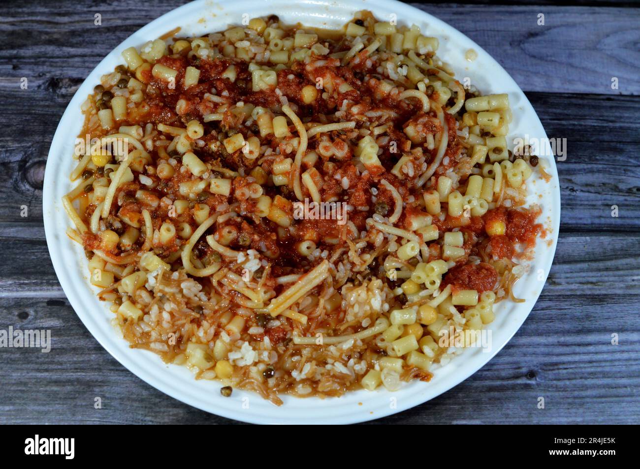 Egyptian cuisine of Koshary, a popular street food made of rice ...