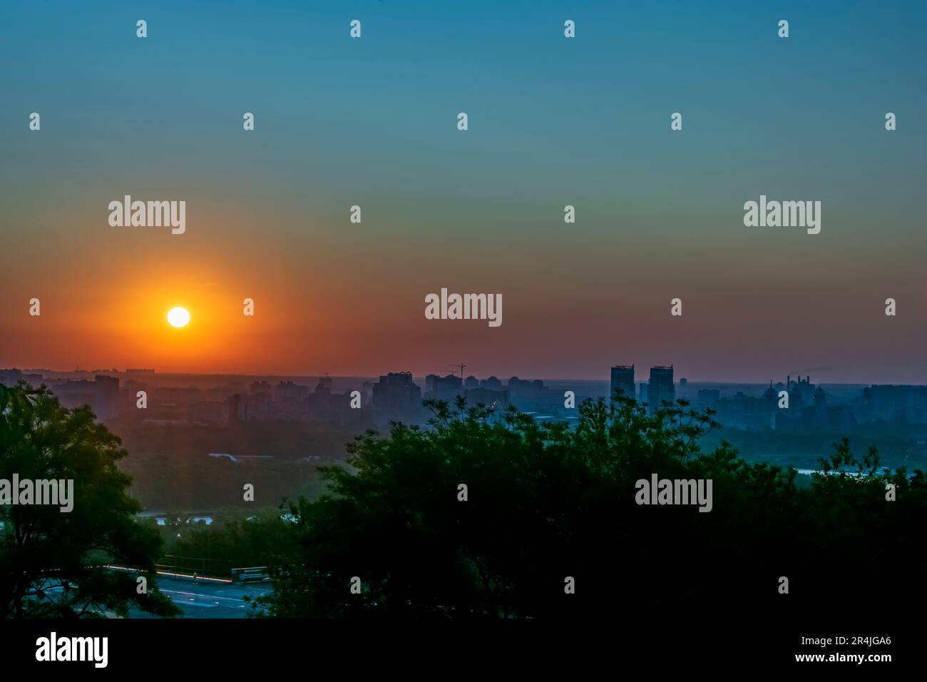 The rising sun above the city Stock Photo - Alamy