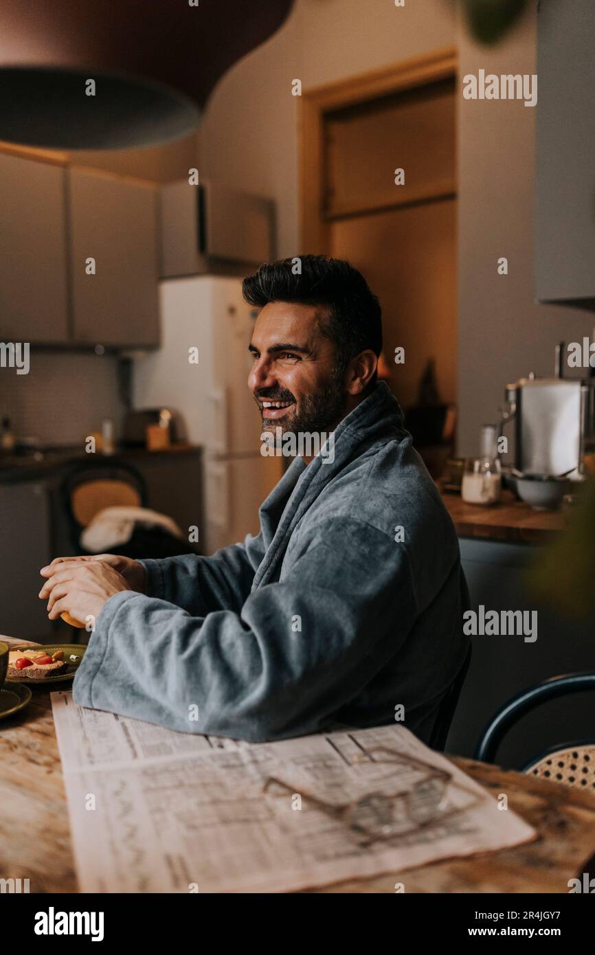 Man wearing bathrobe sitting table hi-res stock photography and images ...
