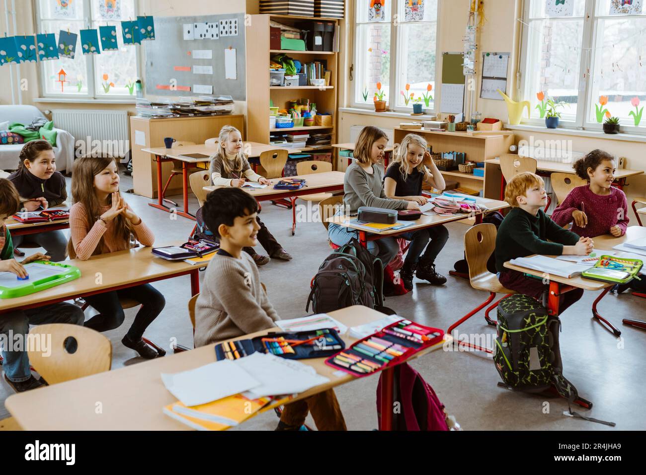 Male and female students attending lecture in classroom at school Stock ...