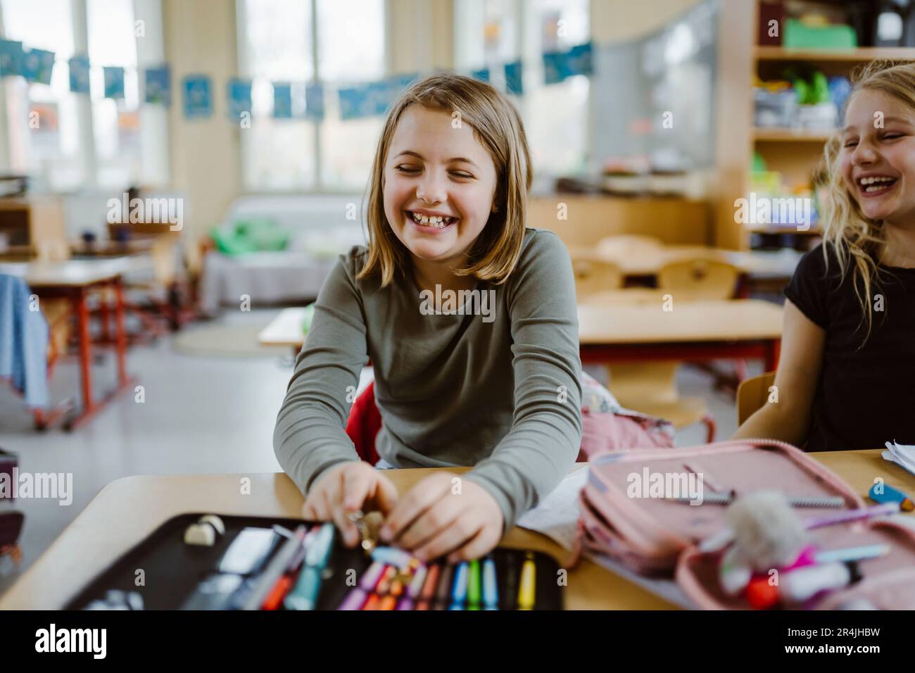 Two girls laughing classroom hi-res stock photography and images - Alamy