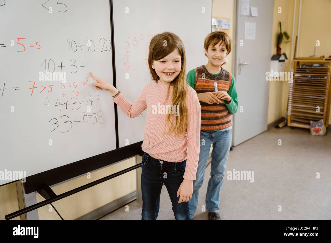 Happy girl solving maths problem with boy in classroom Stock Photo - Alamy Happy girl solving maths problem with boy in classroom Stock Photo - Alamy