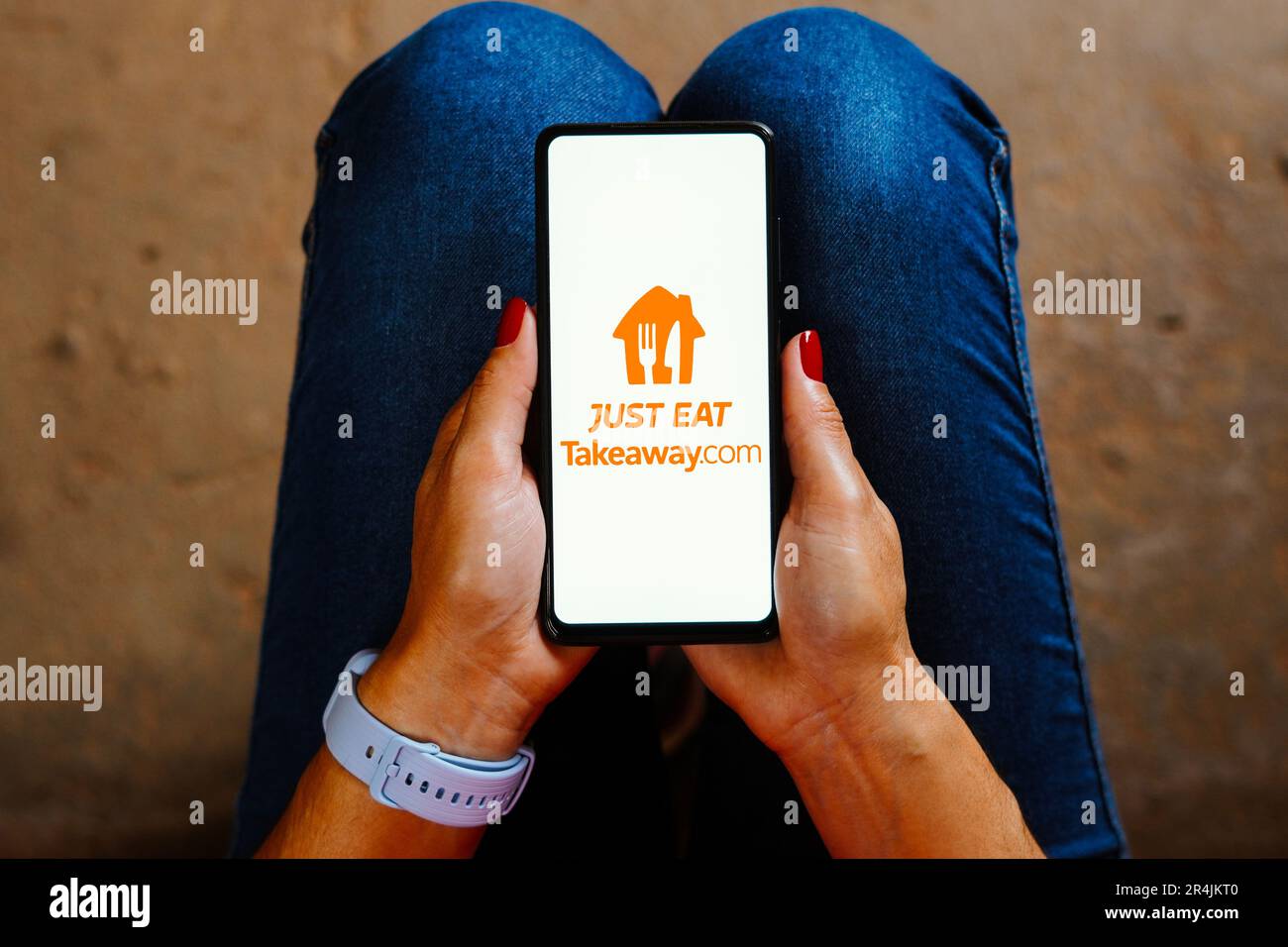 In this photo illustration, the Just Eat Takeaway logo is displayed on ...