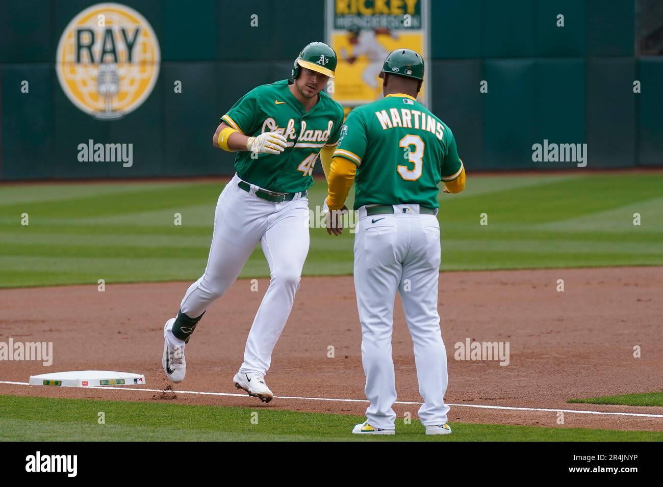 Oakland Athletics' Ryan Noda, left, is congratulated by third base ...