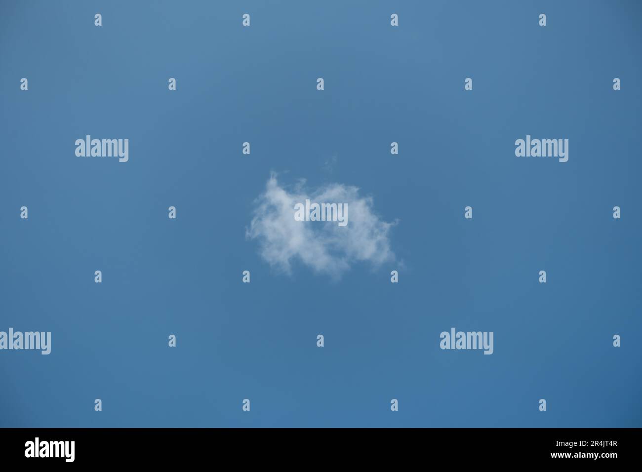 Small white cloud in the blue sky Stock Photo - Alamy