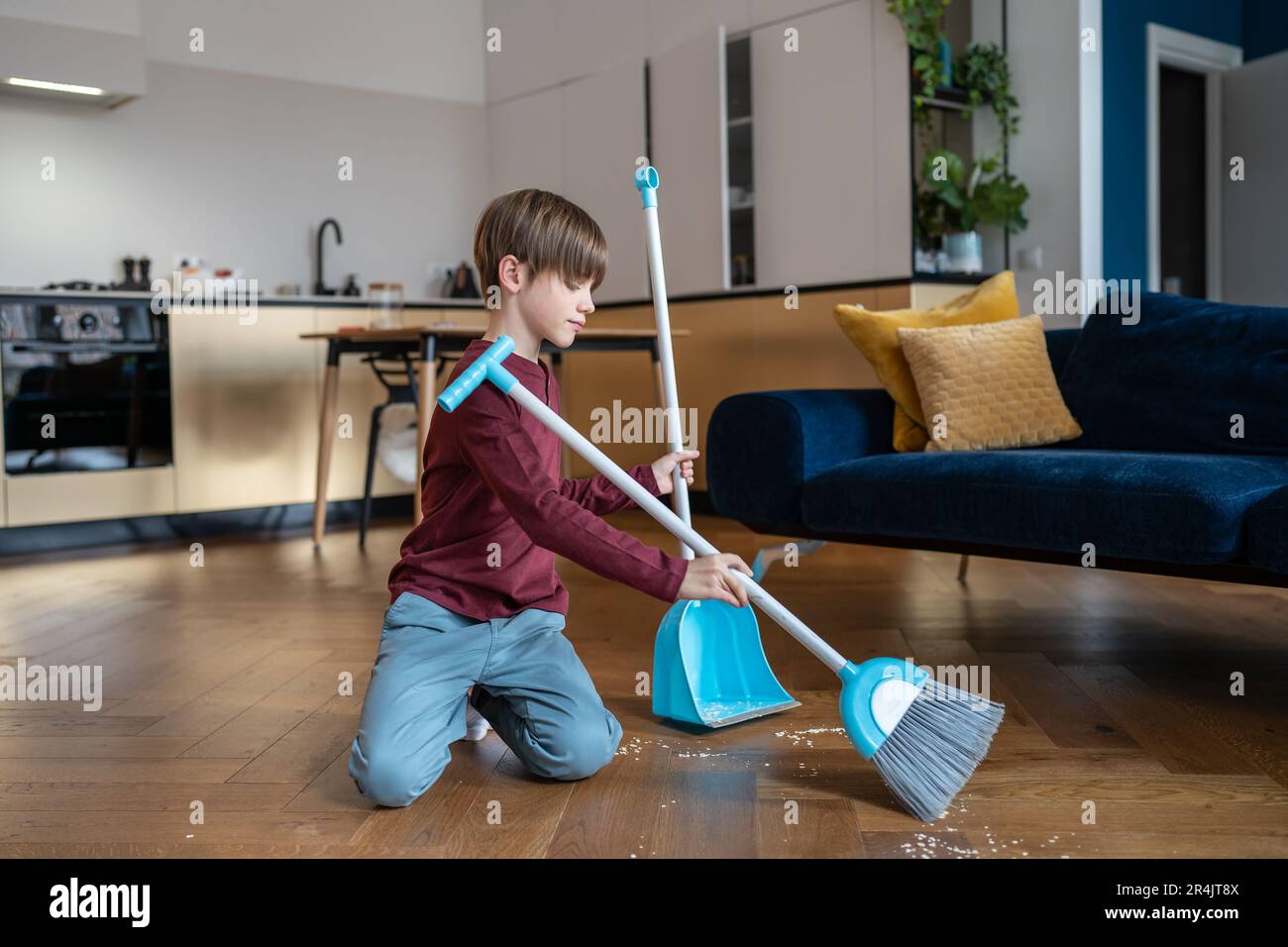 Boy helping with household chores hi-res stock photography and images - Alamy