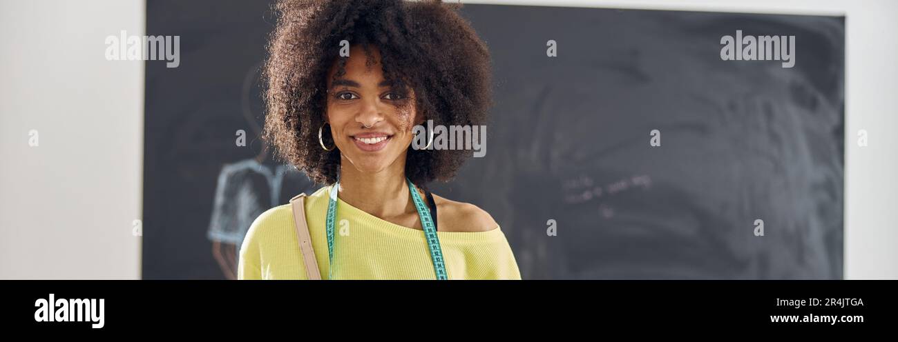 Smiling African-American student with palettes and colored paper Stock ...