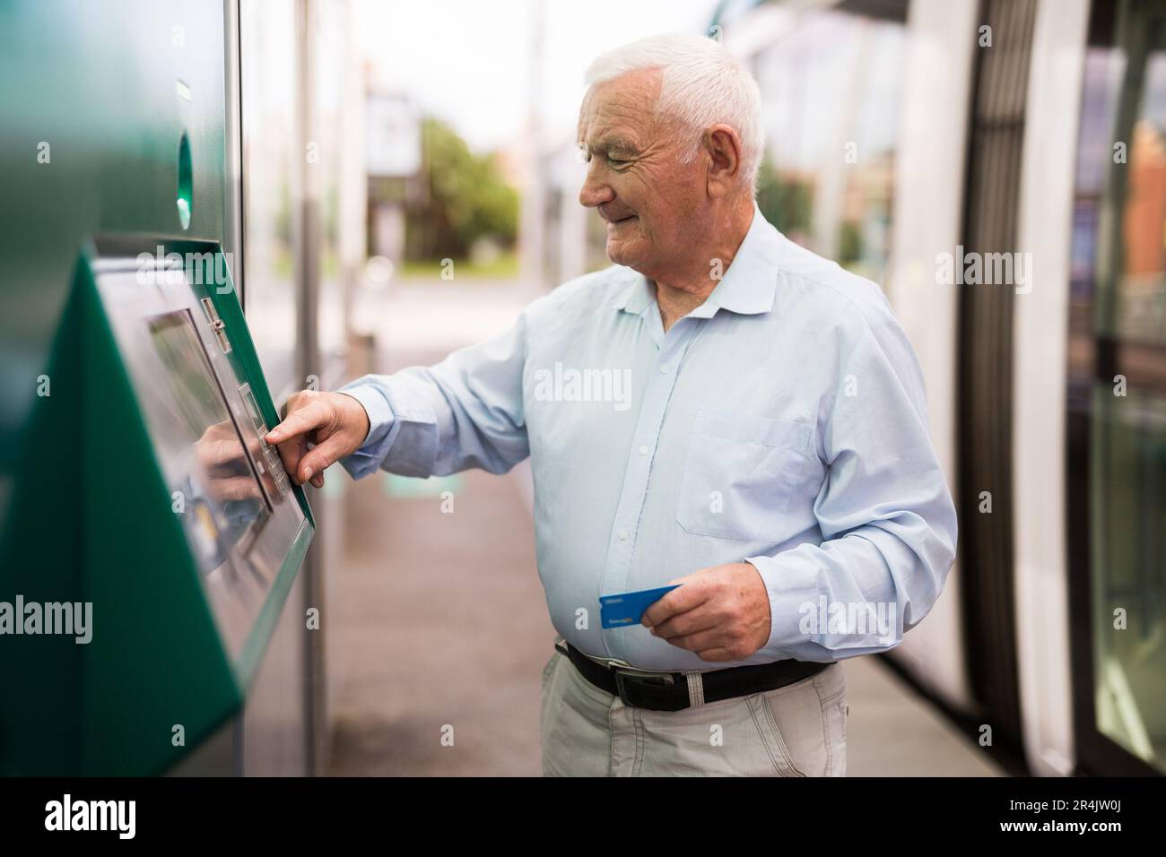 Elderly man using cash machine Stock Photo - Alamy