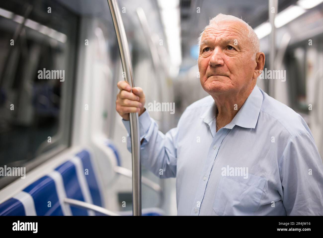 Elderly man in subway train Stock Photo - Alamy