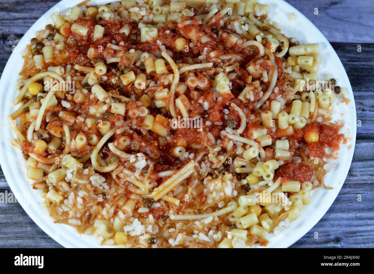 Egyptian cuisine of Koshary, a popular street food made of rice ...