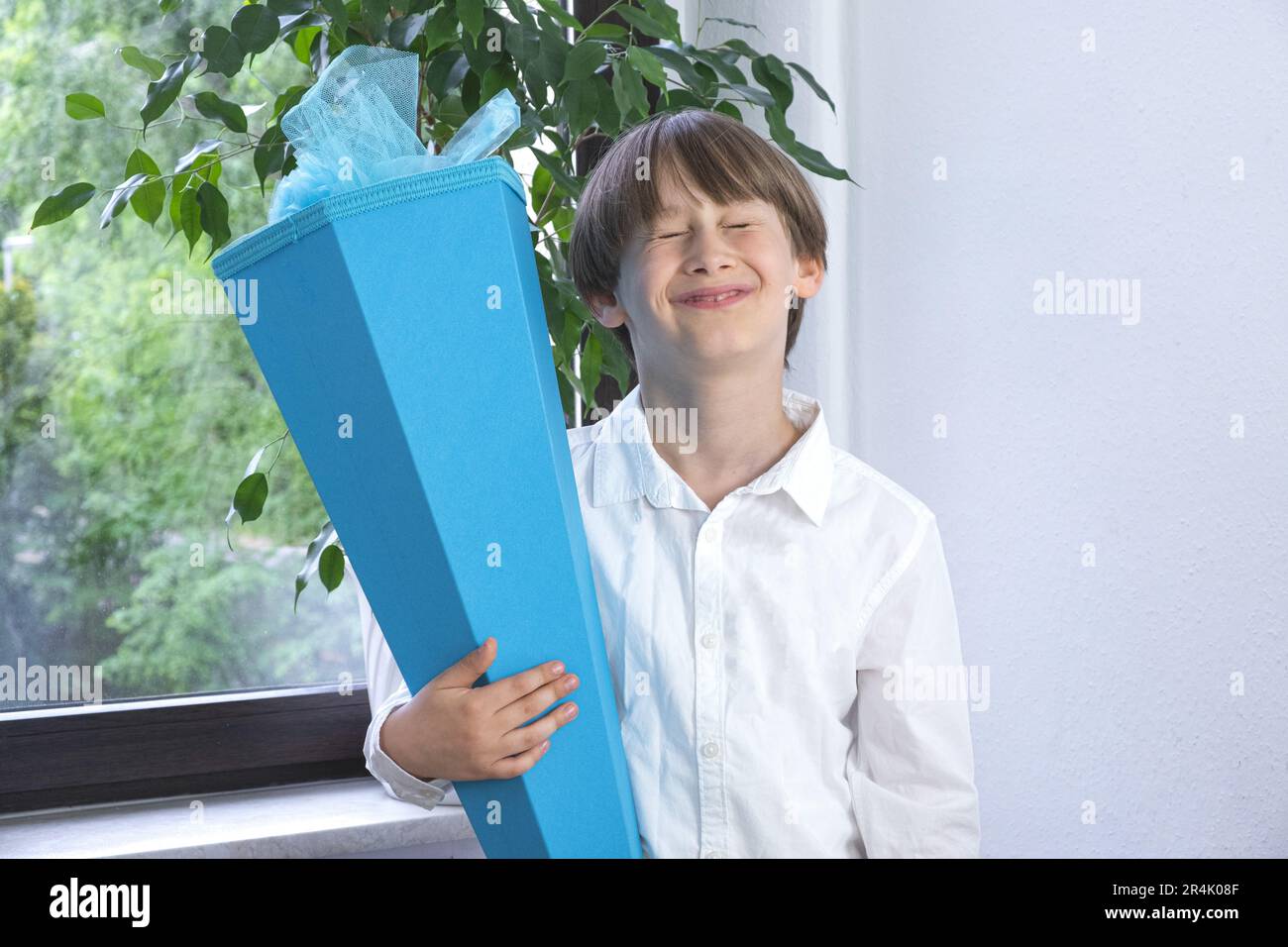 Happy child holding traditional German candy cone on the first school ...