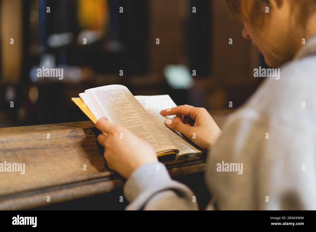 Christian woman reading bible in an ancient Catholic temple. Reading ...
