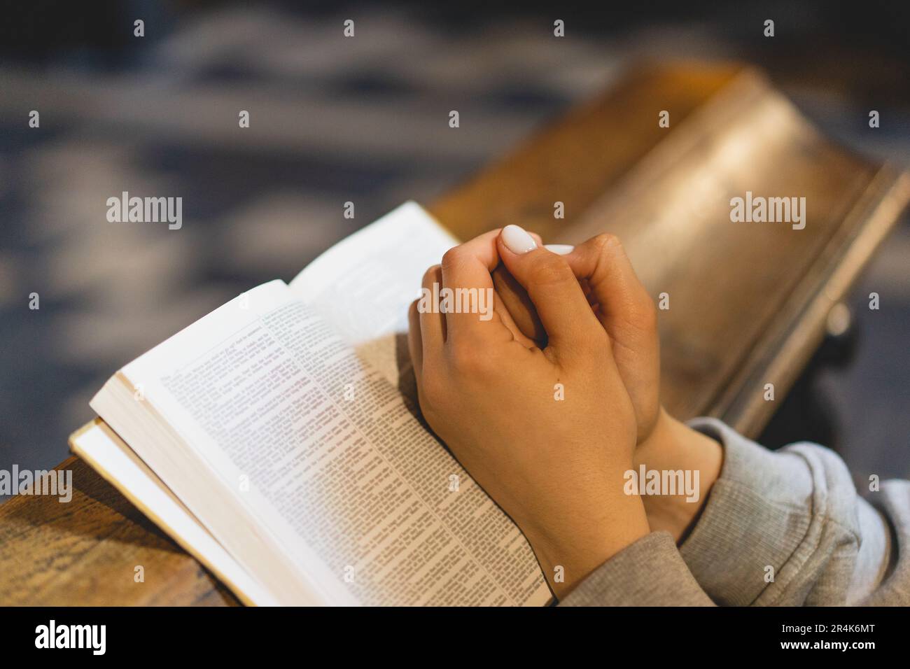 Christian woman reading bible in an ancient Catholic temple. Reading ...