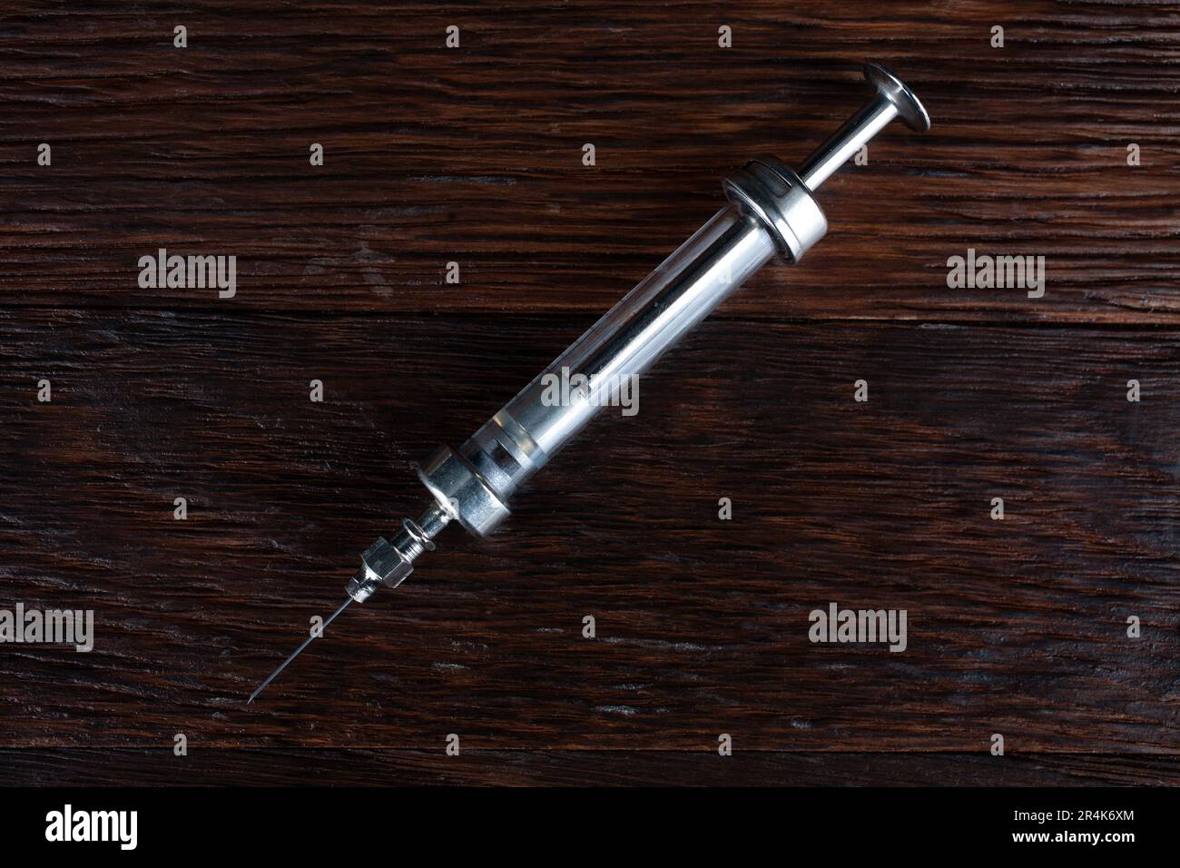 Antique syringe on wooden table background Stock Photo - Alamy