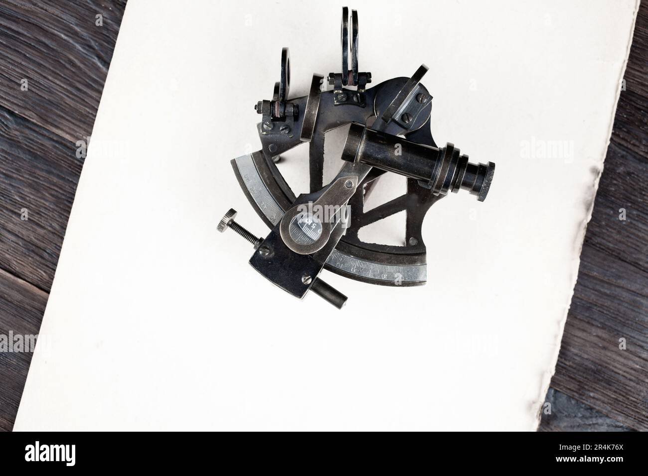 Antique bronze sextant on old paper background Stock Photo - Alamy