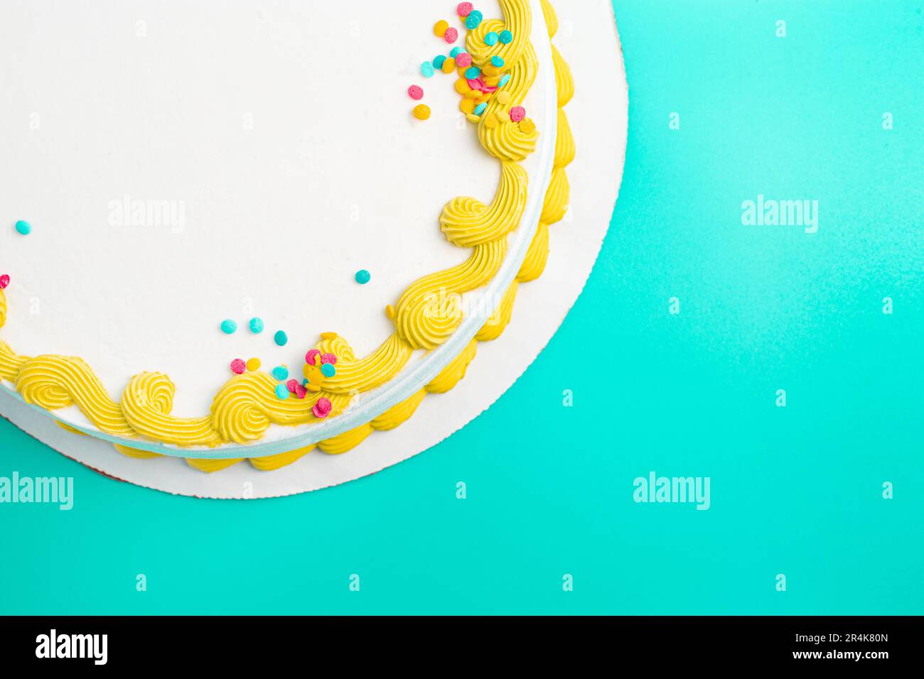 A Circular White Ice Cream Cake with Colorful Border and Sprinkles ...