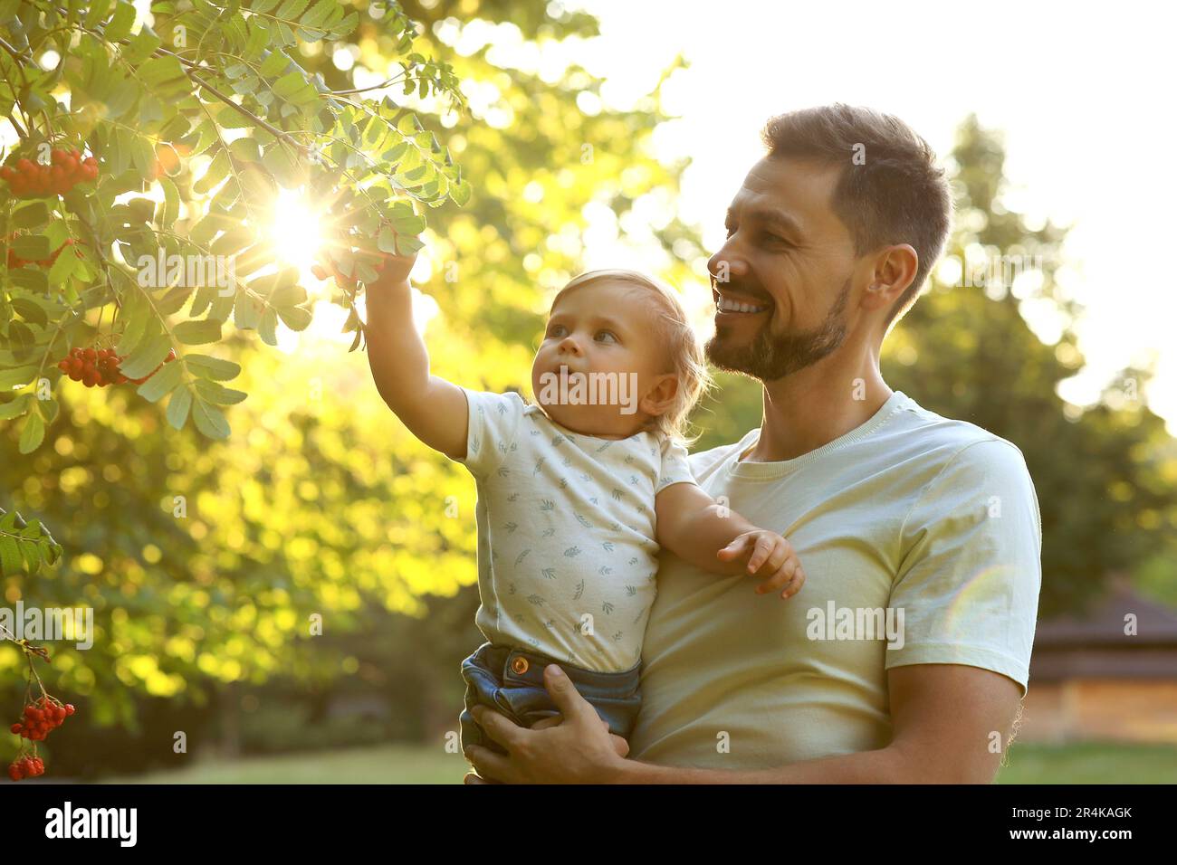 Happy father with his cute daughter in park on sunny day Stock Photo ...