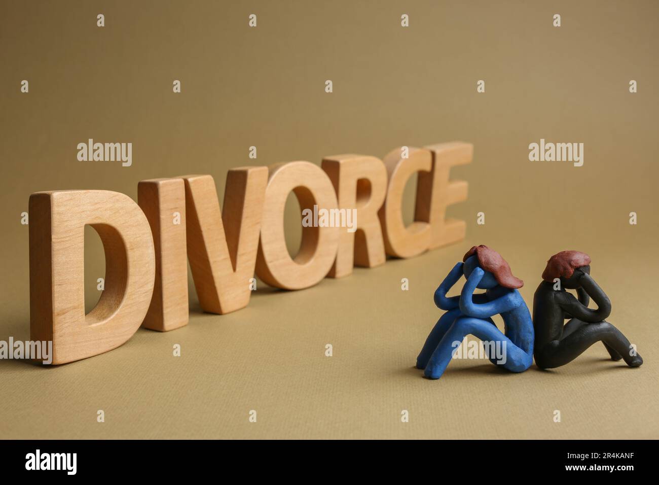 Word Divorce made of wooden letters and plasticine people figures on ...