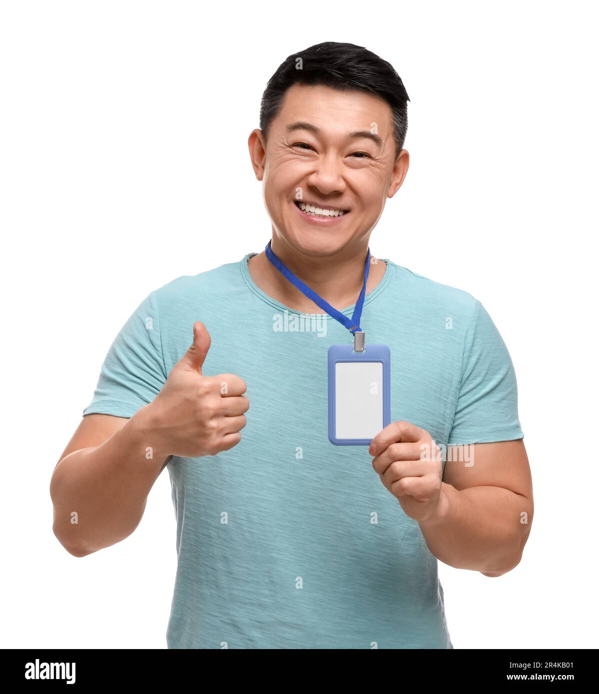 Happy asian man with vip pass badge showing thumbs up on white ...