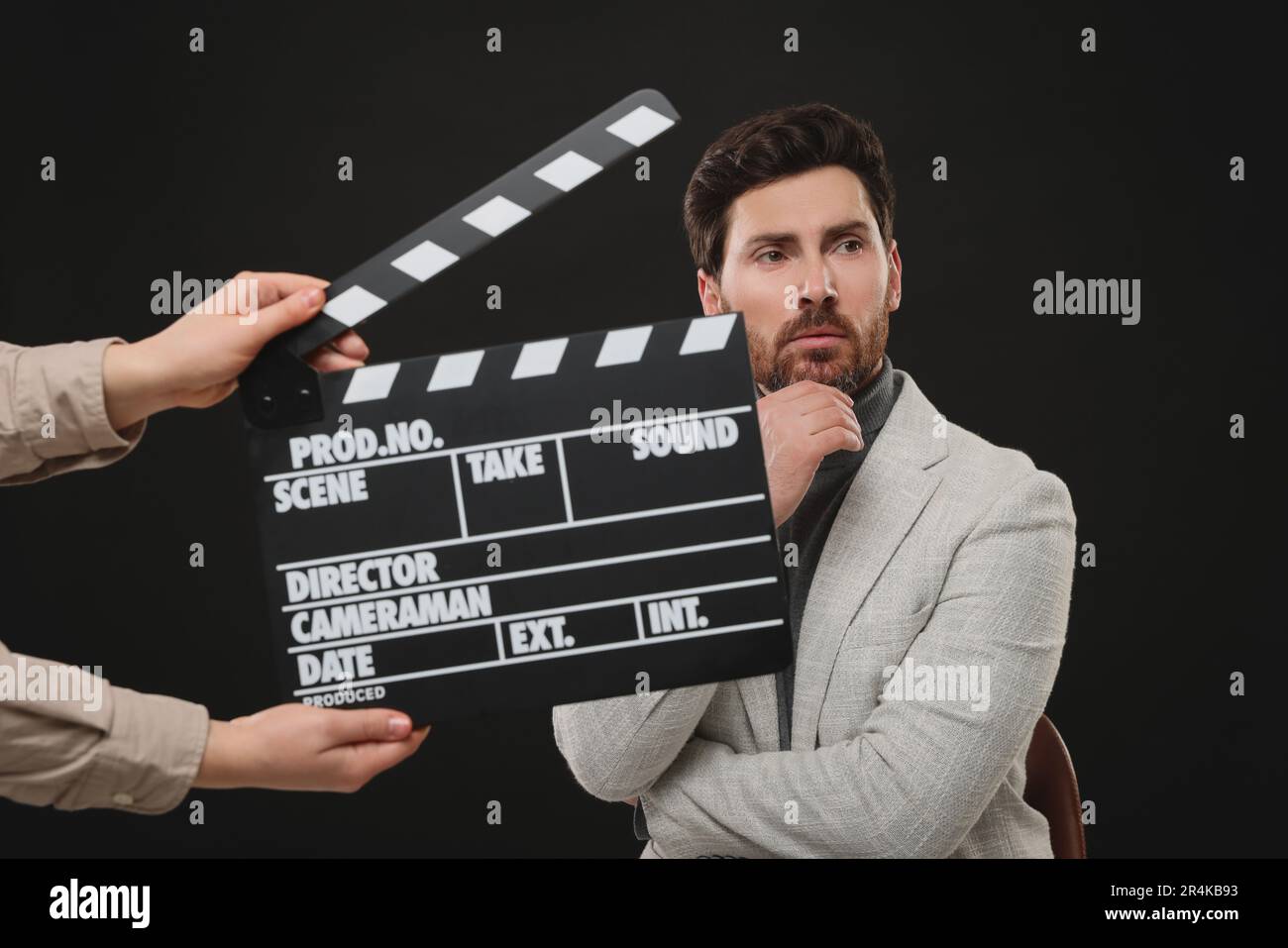 Actor performing while second assistant camera holding clapperboard on ...