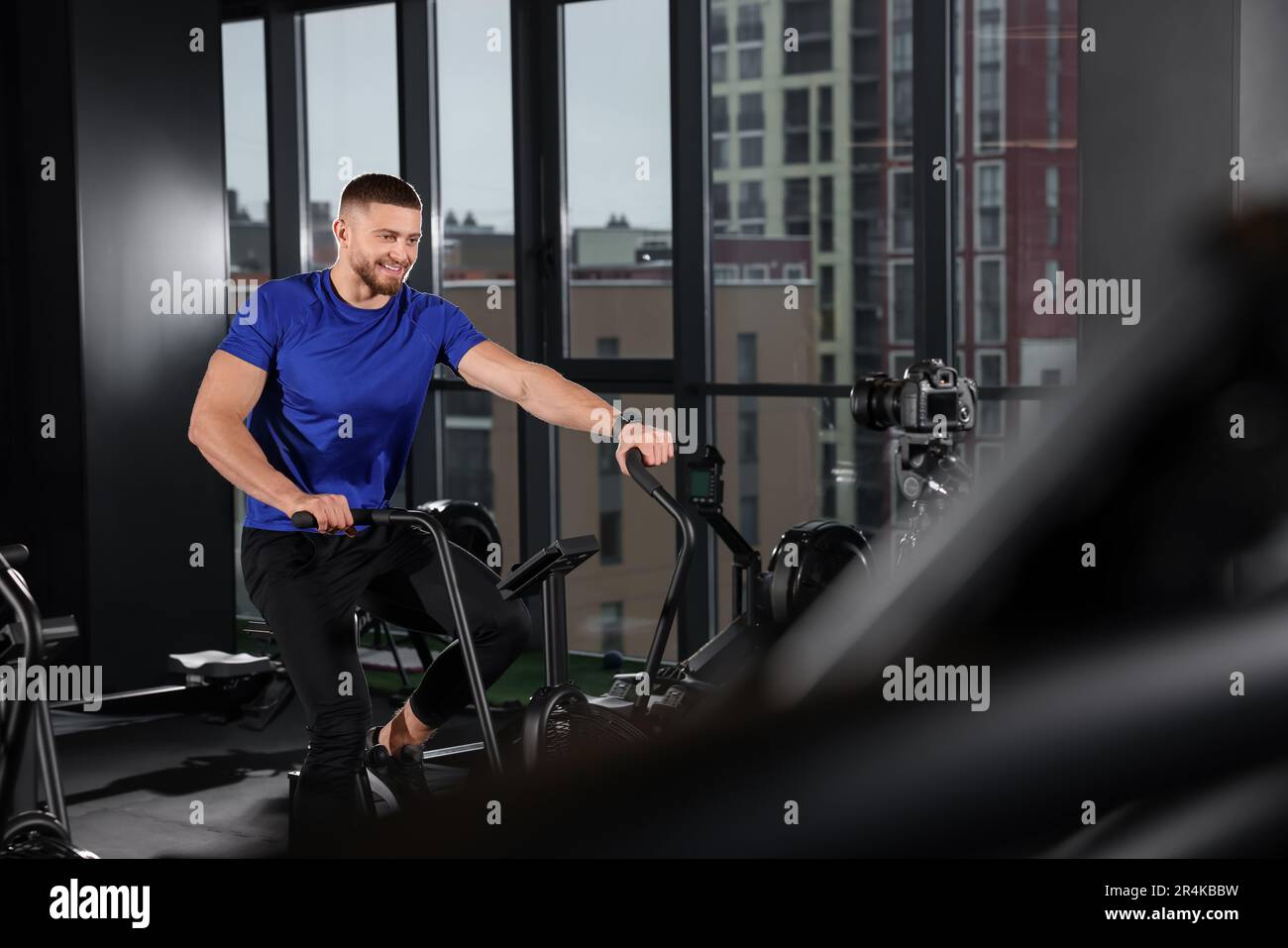 Man recording workout on camera at gym. Online fitness trainer Stock ...