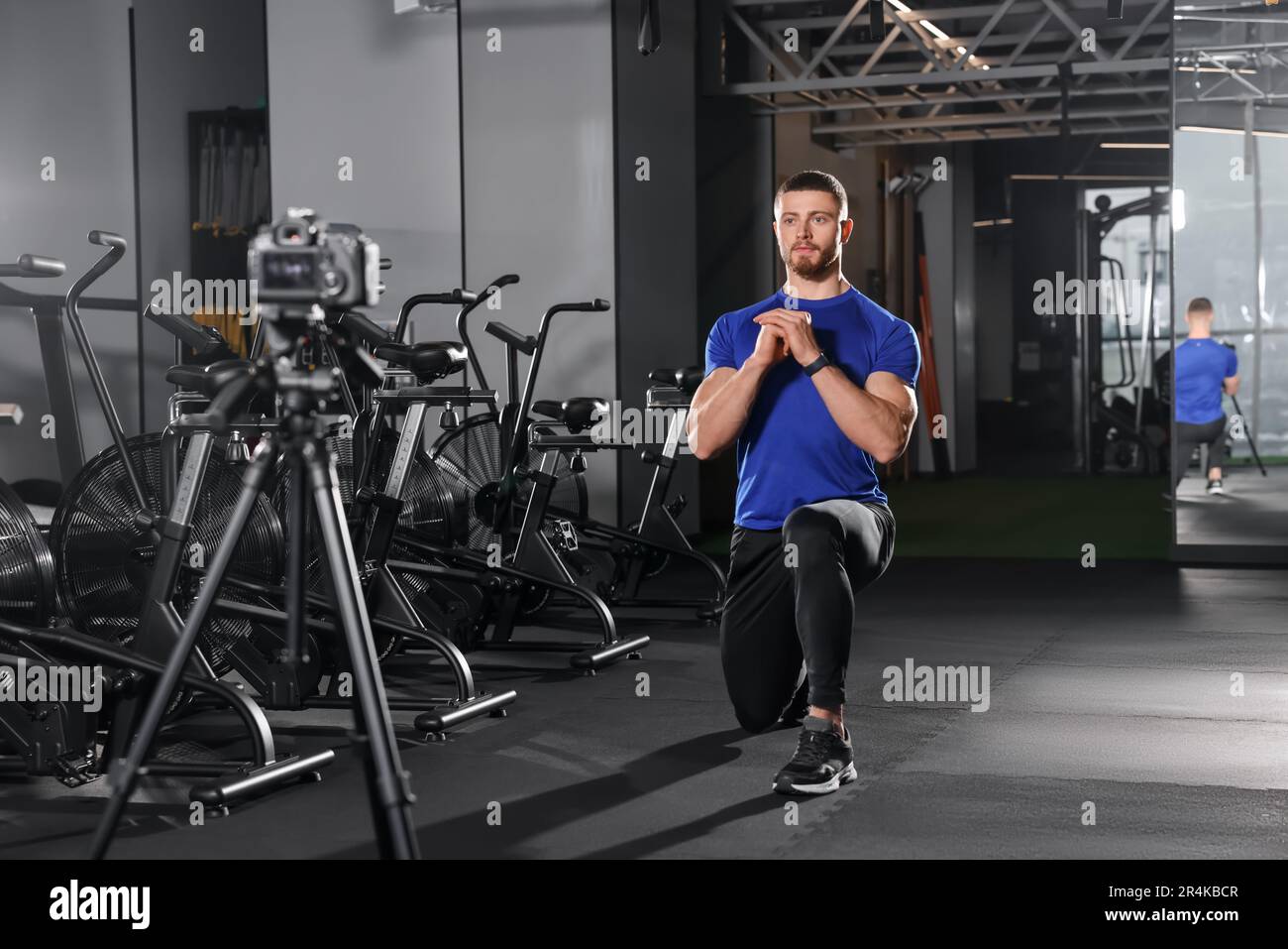 Man recording workout on camera at gym. Online fitness trainer Stock ...