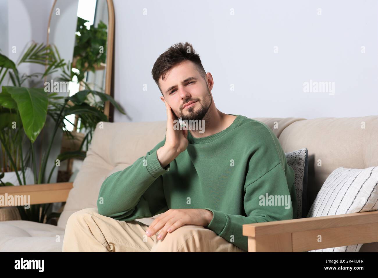 Young man suffering ear pain hi-res stock photography and images - Alamy