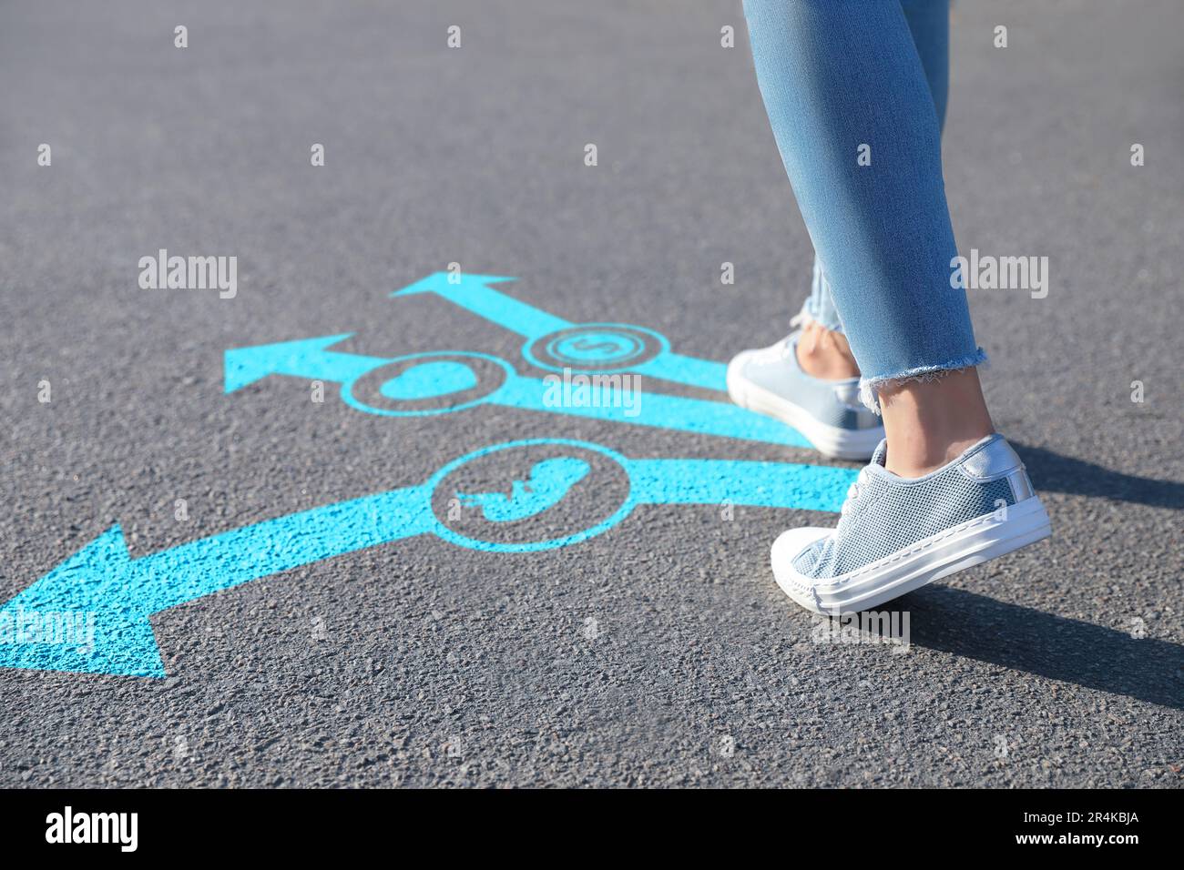 Choice of way. Woman walking towards drawn marks on road, closeup ...